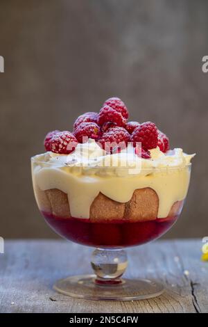 Raspberry trifle with fruit jelly, custard and cream Stock Photo - Alamy