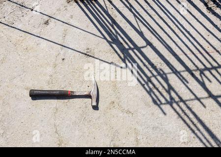 Used tool, mason's hammer, metal handled with rubber, placed on ...