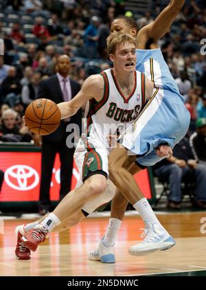 Milwaukee Bucks' Nate Wolters, right, puts up a shot against the ...