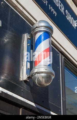 Traditional rotating red and white barbers pole Stock Photo - Alamy