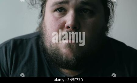 Preoccupied man suffering from mental pain. Close up face of a worried ...