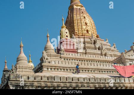 Burmese painter on the roof of Ananda temple in Bagan, Myanmar. Ananda ...