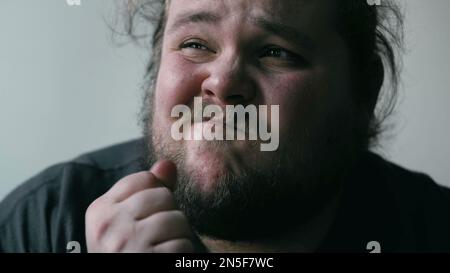 Preoccupied man suffering from mental pain. Close up face of a worried ...