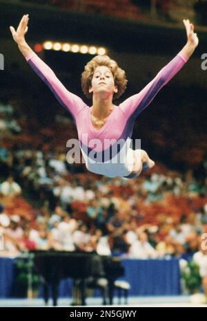 U.S. Gymnast Phoebe Mills flies through the air as she performs her ...