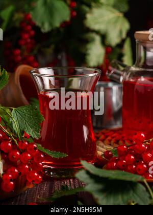 Red currant in tea cup on a white wooden table close up Stock Photo - Alamy