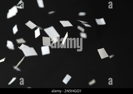 White confetti falling down on light blue background Stock Photo - Alamy