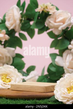 wood podium beige rose flowers on pink pastel background with space ...