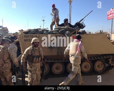 Iraqi soldiers inspect a vehicle during a checkpoint training exercise ...