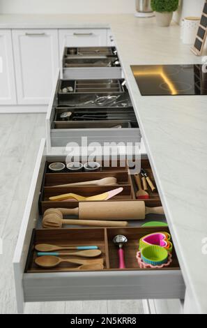 Open drawers with utensils in kitchen, closeup Stock Photo - Alamy