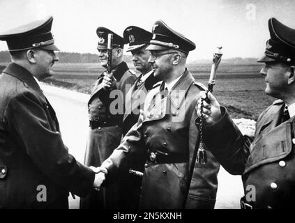 Heinrich Himmler, shaking hands with Adolf Hitler. Ca. 1940. Himmler ...