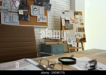 Modern detective office with workplace and board Stock Photo - Alamy