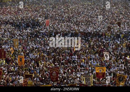 Filipino Catholic devotees wave their white handkerchiefs during a mass ...