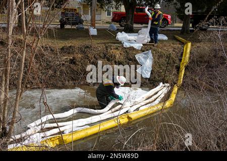 HEPACO workers place booms in a stream in East Palestine, Ohio ...