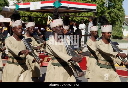 Hundreds of Sudanese watch a parade commemorating the 58th anniversary ...