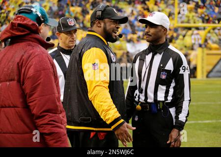 Referee Mike Carey, left, talks to the booth in the first half of an ...