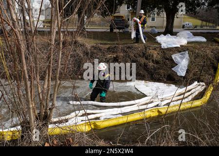 HEPACO workers place booms in a stream in East Palestine, Ohio ...