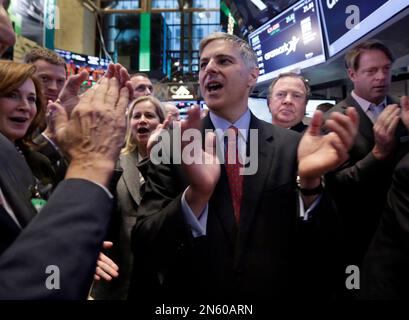 CEO of Hilton Worldwide Christopher Nassetta, center, poses in a Hilton ...