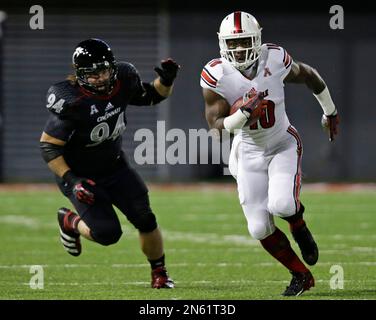 Louisville running back Dominique Brown (10) tries to hurdle Miami ...