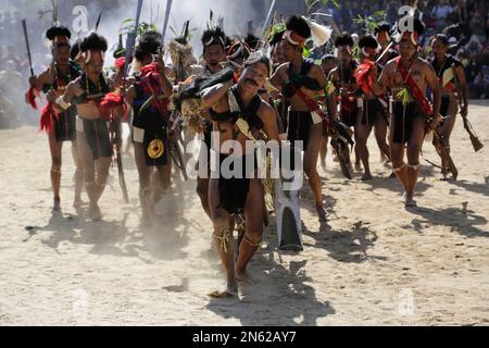 India's Naga tribal men in traditional attire perform a head hunting ...
