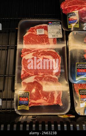 Raw ribeye steaks in package and savory spices. Flat lay Stock Photo ...