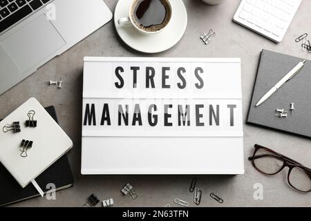 Flat lay composition with words Stress Management and office supplies ...