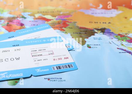 Avia tickets on world map, flat lay. Travel agency concept Stock Photo ...