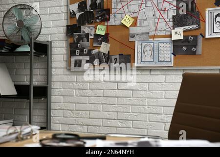 Modern detective office with workplace and board Stock Photo - Alamy