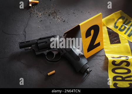 Composition with gun on black slate table, closeup. Crime scene Stock ...
