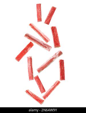 Many fresh crab sticks falling on white background Stock Photo - Alamy