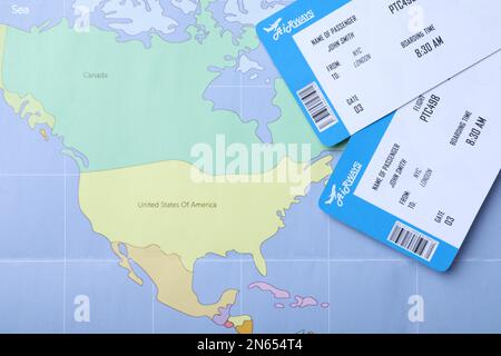 Tickets on world map, flat lay. Travel agency concept Stock Photo - Alamy