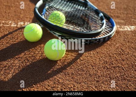 Tennis balls and rackets on clay court, flat lay Stock Photo - Alamy