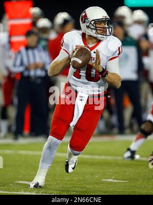 Ball State quarterback Keith Wenning (10) looks to pass as he is chased ...