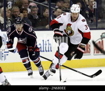 Ottawa Senators' Marc Methot, right, knocks the puck off the stick of ...