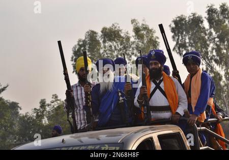 Nihangs, or Sikh religious warriors, display their weapons at an event ...