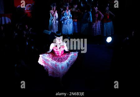 A Bolivian "chola" woman in traditional clothes walks on the "Isla de ...