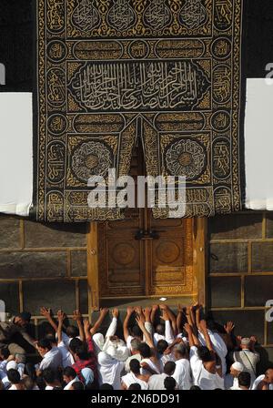 Muslim pilgrims pray at the door of the Kaaba, the cube-shaped ...
