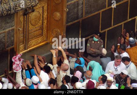 Muslim pilgrims pray at the door of the Kaaba, the cube-shaped ...