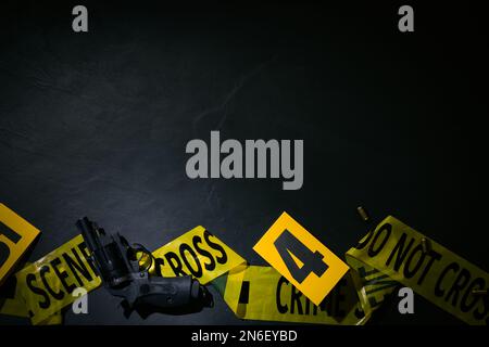 Composition with gun on black slate table, closeup. Crime scene Stock ...