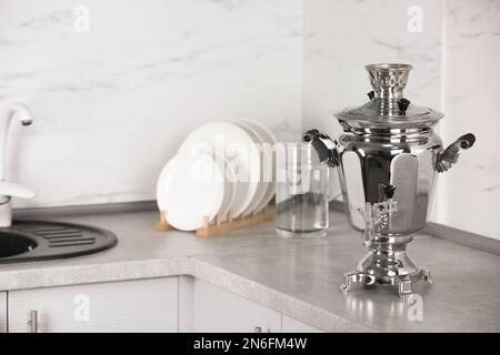 Metal samovar on grey countertop in kitchen. Russian tea culture Stock ...