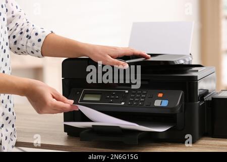 Employee using modern printer in office, closeup Stock Photo - Alamy