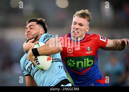 Mawene Hiroti of the Sharks is tackled by Riley Jones of the Knights ...