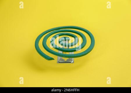 New insect repellent coil on yellow background Stock Photo - Alamy