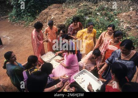 Kodava women making rice ball, Kadamputtu, during Huthri festival ...