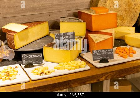 Variety of cheeses on display in cheese room of farm shop, Suffolk ...