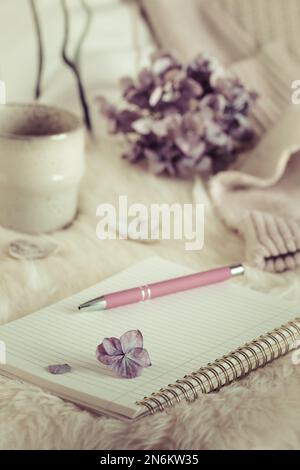 Notebook with pen and lilac Stock Photo - Alamy