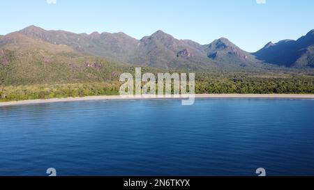 Aerial shot of Zoe Bay with the beach and mountains of Hinchinbrook ...