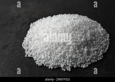 Pellets of ammonium nitrate on grey table. Mineral fertilizer Stock ...