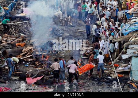 People prepare funeral pyres in Varanasi on the banks of the Ganges ...