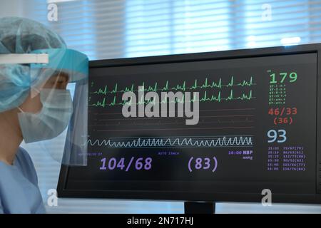 Nurse near monitor with cardiogram in hospital Stock Photo - Alamy