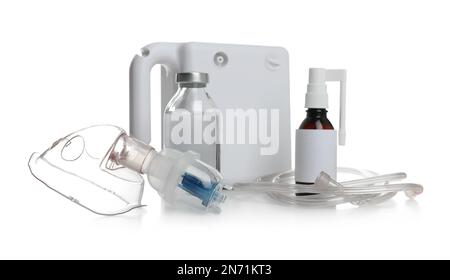 Modern nebulizer with face mask and medications on white background ...